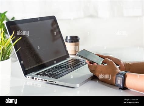 Programmer Woman Looking Mobile Phone Program Code At Workplace