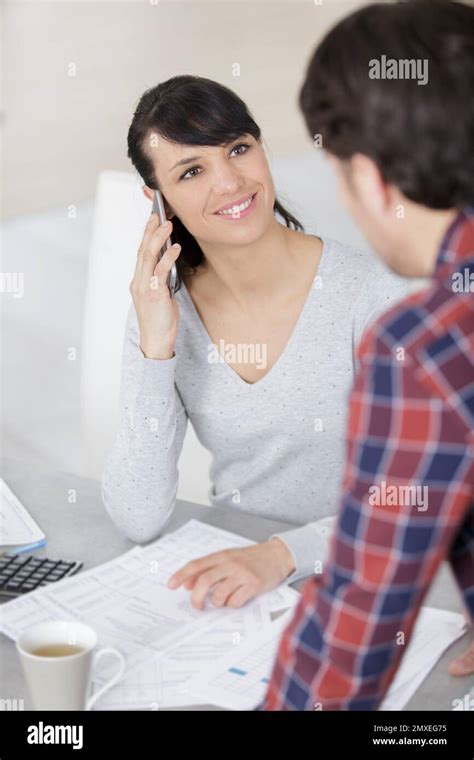 A Smiling Couple Calculating Bills Stock Photo Alamy