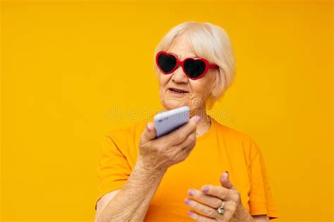 Elderly Woman Happy Lifestyle In Yellow T Shirts Glasses Background