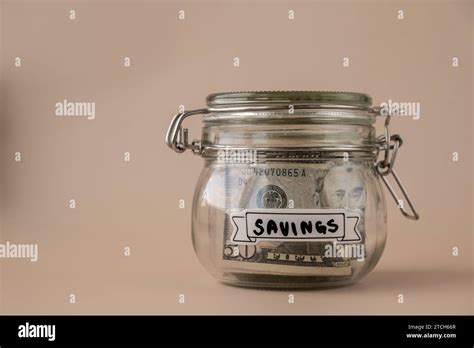 saving money in glass jar filled with dollars banknotes savings