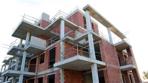 Construction Progress Of A Modern Multi Story Building In An Urban Area During Daylight Hours
