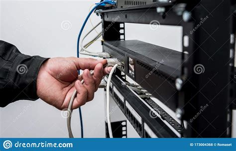 Technician Connecting Network Cables To Switches Connecting Cables Stock Photo Image Of