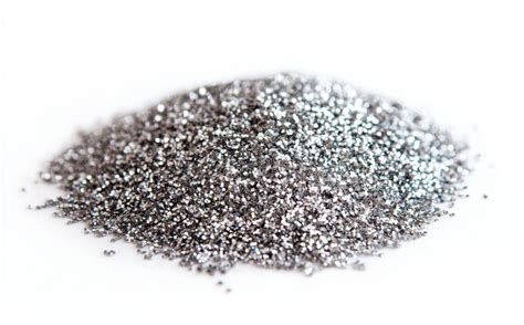 In Daylight Metallic Silver Particles Scatter Across A White Surface