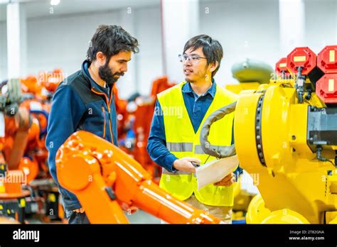 Japanese And Caucasian Engineers Controlling The Production Of