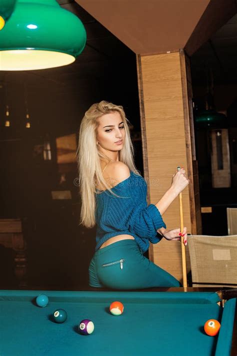 Vertical Portrait Of Young Fashionable Girl Posing On Pool Table Stock