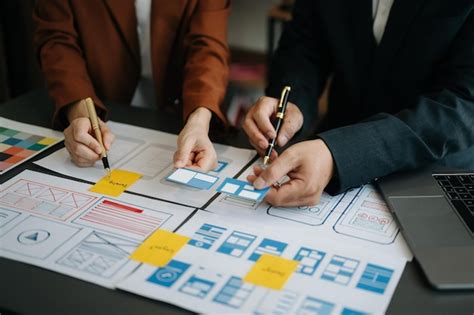 Premium Photo Ux Developer And Ui Designer Brainstorming About Mobile App Interface Wireframe