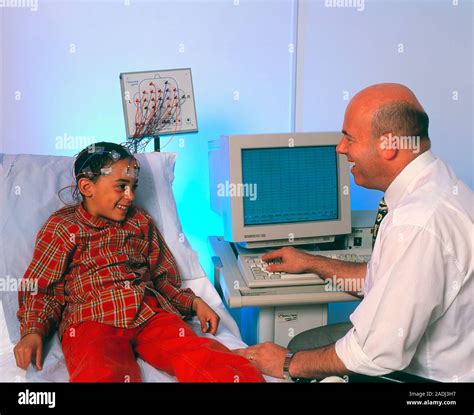 Electroencephalography Doctor Monitoring A Young Boys Brain Activity