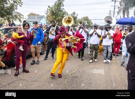 A Second Line Parade Moving Through The Streets Of The Treme