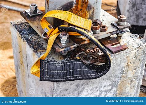 The Safety Belt Of A Welder Or Assembler Lies On A Concrete Foundation