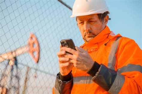 Drilling Rig Engineer Using Mobile Phone While Supervising The Process