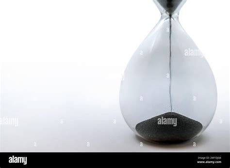 Black Sand Hourglass Against White Background With Copy Space Stock