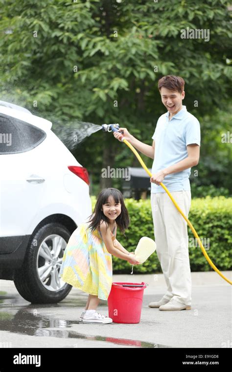 Girl Helping Father Cleaning Car Stock Photo Alamy