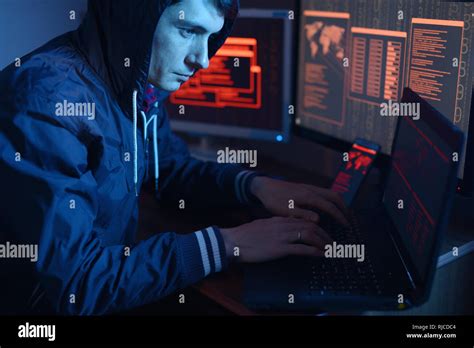 Hacker Typing Program Code While Committing A Cybercrime Hacking A System Firewall On The