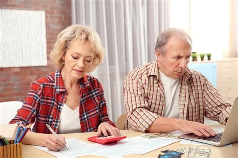 Premium Photo Senior Couple Calculating Taxes At Home
