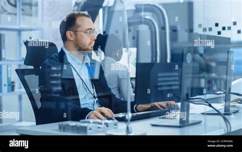 factory office industrial engineer working on personal computer on