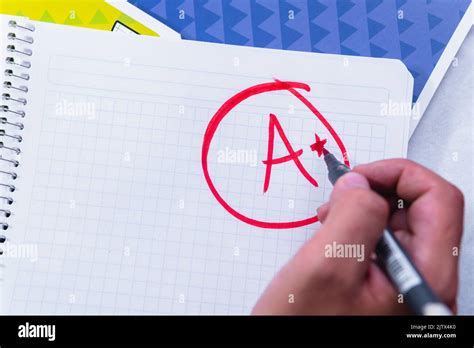 Teacher Giving An A To A Students Assignment Blank Sheet With Copy