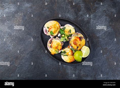 Baked Seafood Shellfish Scallops With Cheese And Lemon Black