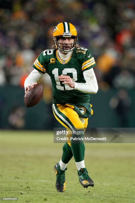 Quarterback Aaron Rodgers Of The Green Bay Packers Scrambles For A