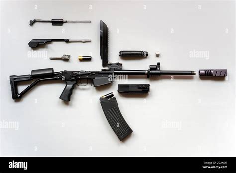 Disassembled Machine Gun On A Gray Background Isolated Details Of