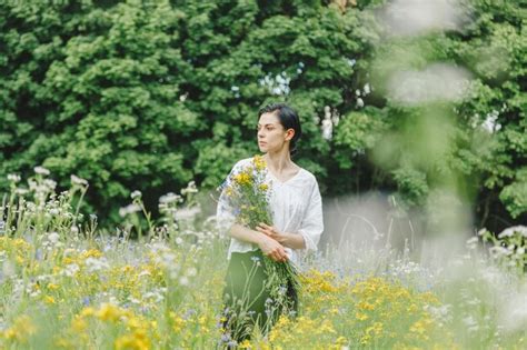 Premium Photo Beautiful Girl Among The Summer Field With Wildflowers