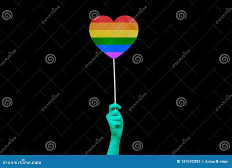 Lgbt Pride Month The Girl`s Hand Holds A Rainbow Heart On A Black