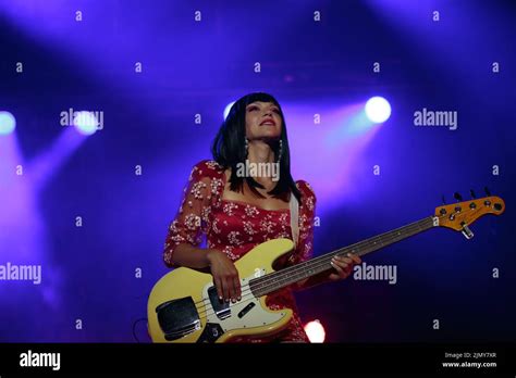 Bassist Laura Lee Of Khruangbin On Stage Wearing A Red Floral Mini