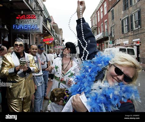 A Woman Catches A Strand Of Beads After Flashing On Bourbon Street