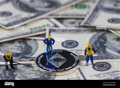Miniature People Worker Digging Silver Ethereum Coin On Hundred Dollar Bill Virtual