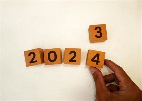 Premium Photo Hand Flipping Block 2023 To 2024 Text On Table Resolution Time Plan Goal