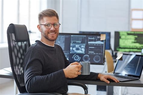 Premium Photo Portrait Of Software Programmer Smiling At Camera While Posing At Workplace In
