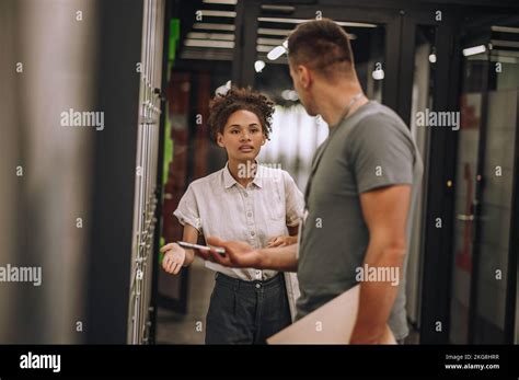 Female Employee Having A Conversation With Her Coworker Stock Photo Alamy