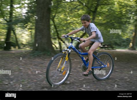 Boy Having Fun Riding Alone On His Bike In A Forest Canejan Gironde France Stock Photo Alamy