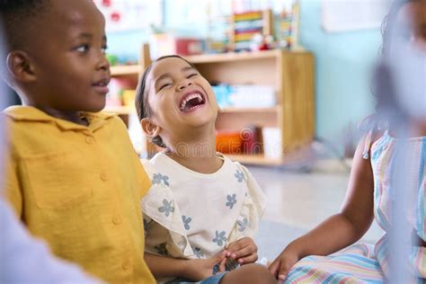 Primary Or Elementary School Class Having Fun With Model Wind Turbine Learning About Environment