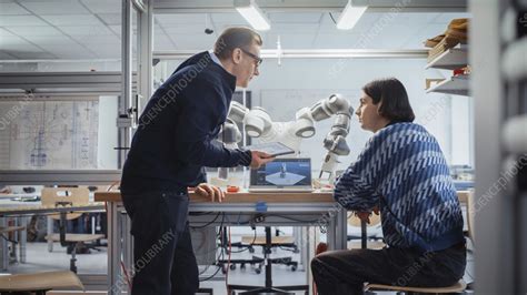 Engineers Discussing Robotic Arms In Research Laboratory Stock Image F043 4231 Science