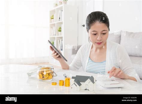 Elegant Beauty Girl Using Calculator Counting Personal Deposit When She Choosing New House
