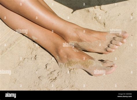 Women Legs On The Sand Stock Photo Alamy