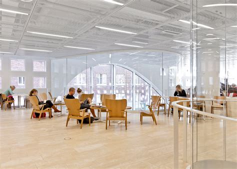 Curving Voids Pierce The Floors Of Anttinen Oivas Helsinki Library