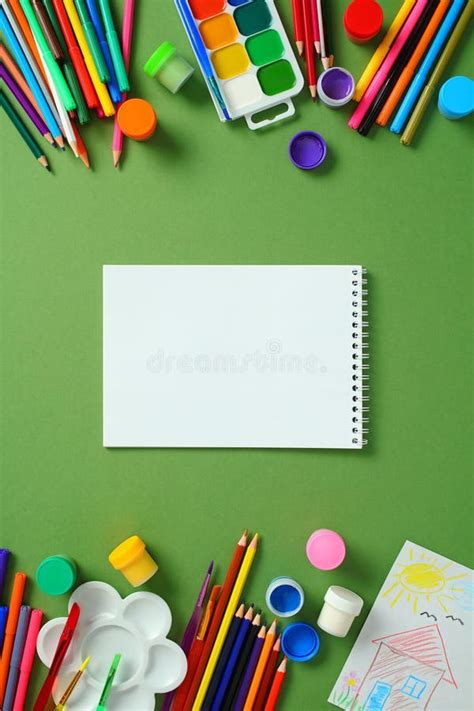 Blank Spiral Notebook Mockup With Art Supplies On Green Background Flat Lay Top View Stock