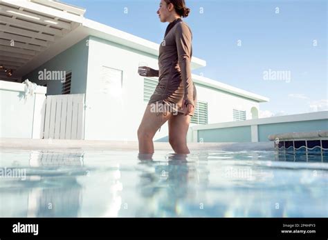 Solo Woman With Drink Enjoying A Dip In The Pool In Puerto Rico Stock