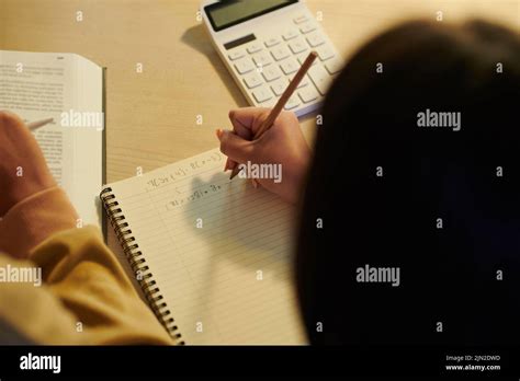 Babegirl Solving Equations And Writing In Textbook View Over Shoulder Stock Photo Alamy