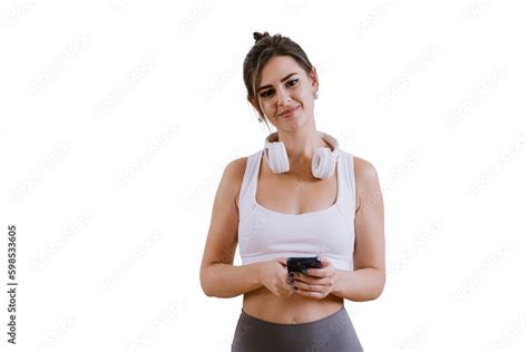 Attractive Brunette American Girl In Sportswear And Headphones On Neck