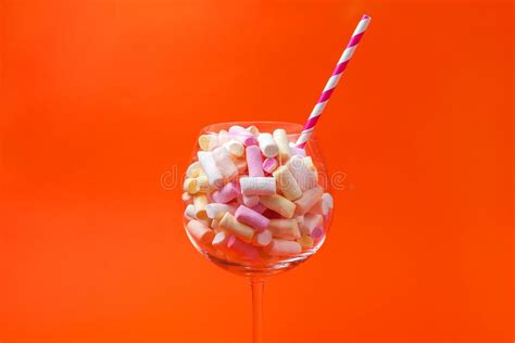 Mini Marshmallows In A Glass On A Bright Orange Background Multi Colored Marshmallows In A