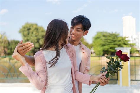 Romantic Valentine Surprise Outdoor Park Couple Holding Roses Bright Day Intimate Moment For