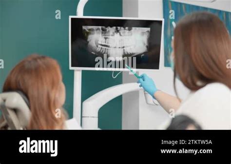 The Dentist Shows The Woman X Rays Of Her Teeth For A Detailed Examination The Dentist Uses