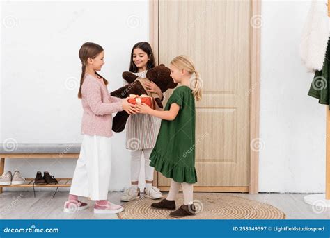Smiling Girls Holding Soft Toy And Stock Image Image Of Preteen