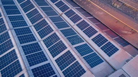 A Large Solar Cell Roof On An Industrial Building Generating Electricity For The Plant Stock