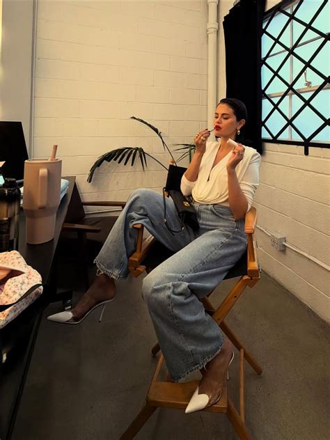 Selena Gomez Behind The Scenes In White Top And Wide Leg Jeans • Celebmafia