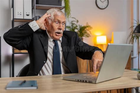 Frustrated Senior Businessman Grandpa In Suit Having Software Problems With Laptop At Home