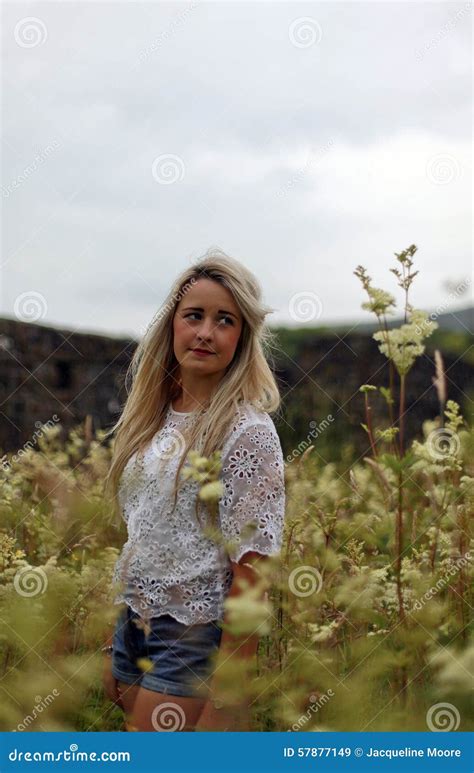 Pretty Teenage Girl With Long Blonde Hair Standing In A Field Of Stock