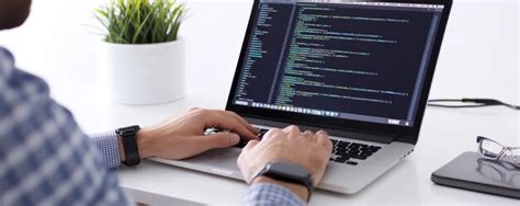 realistic image of developer typing code at laptop premium ai generated image